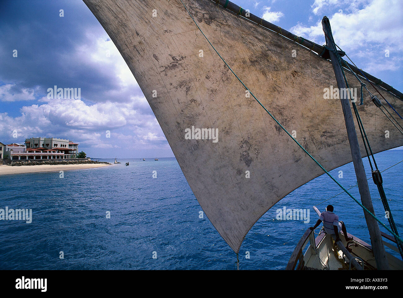 Sail of a traditional merchant ship, in the background Hotel Serena ...