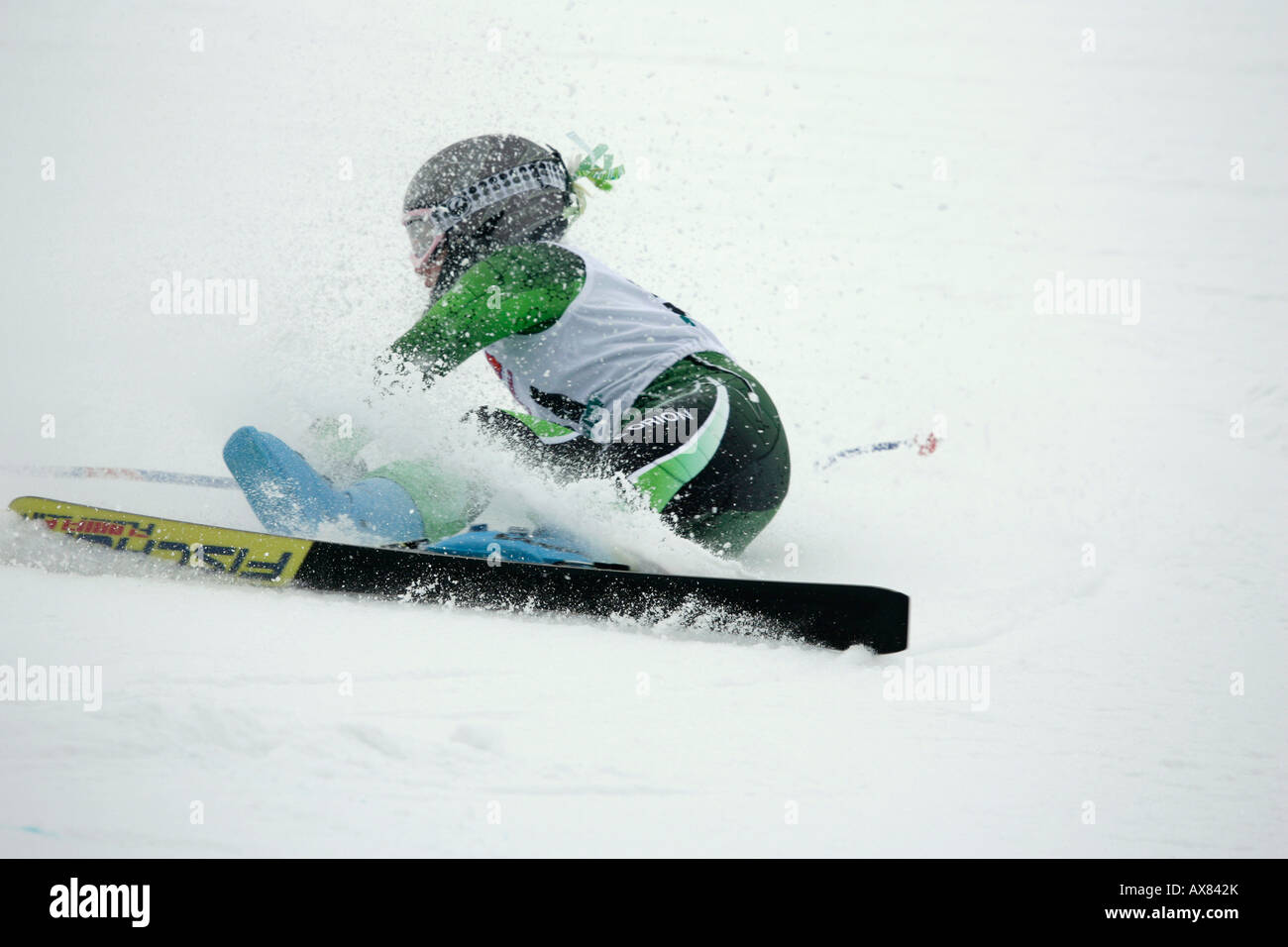 A snow skier falling during a downhill race Stock Photo - Alamy