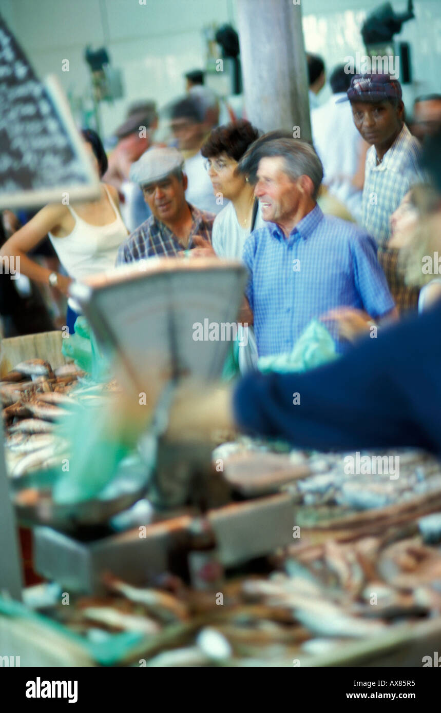 People at a fish stand at the market hall, Loulé, Faro, Algarve ...