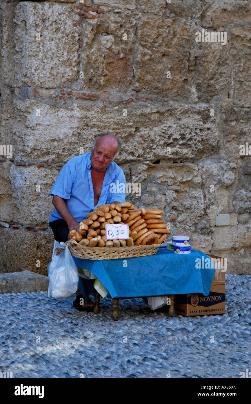 Man selling bread in Old Town area of Rhodes, Greece Stock Photo - Alamy