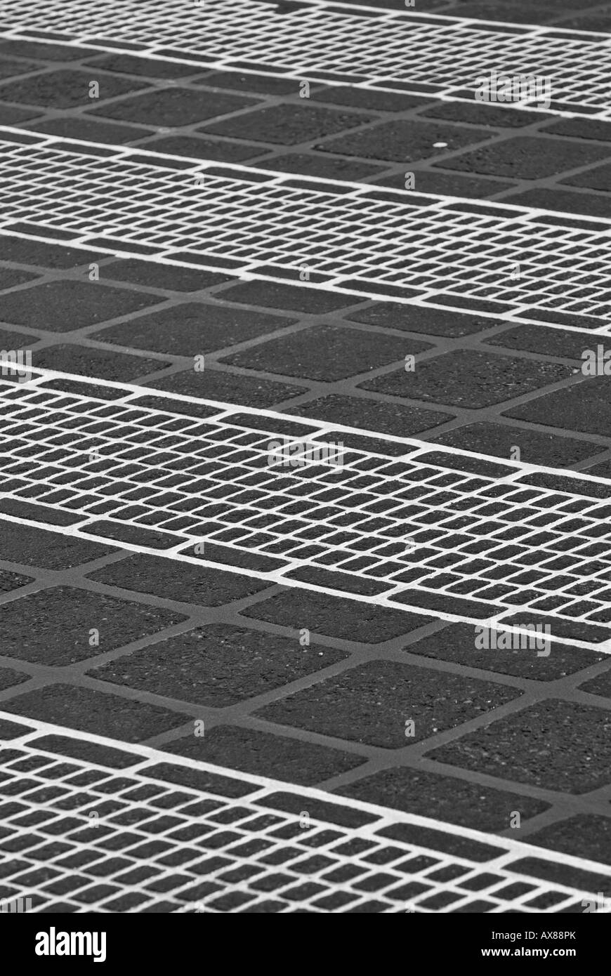 The graphic lines of a pedestrian sidewalk crossing on the surface of a ...