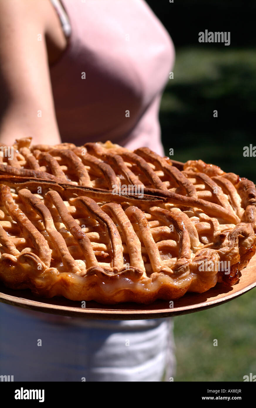 Woman showing an apple pie outdoors Stock Photo - Alamy