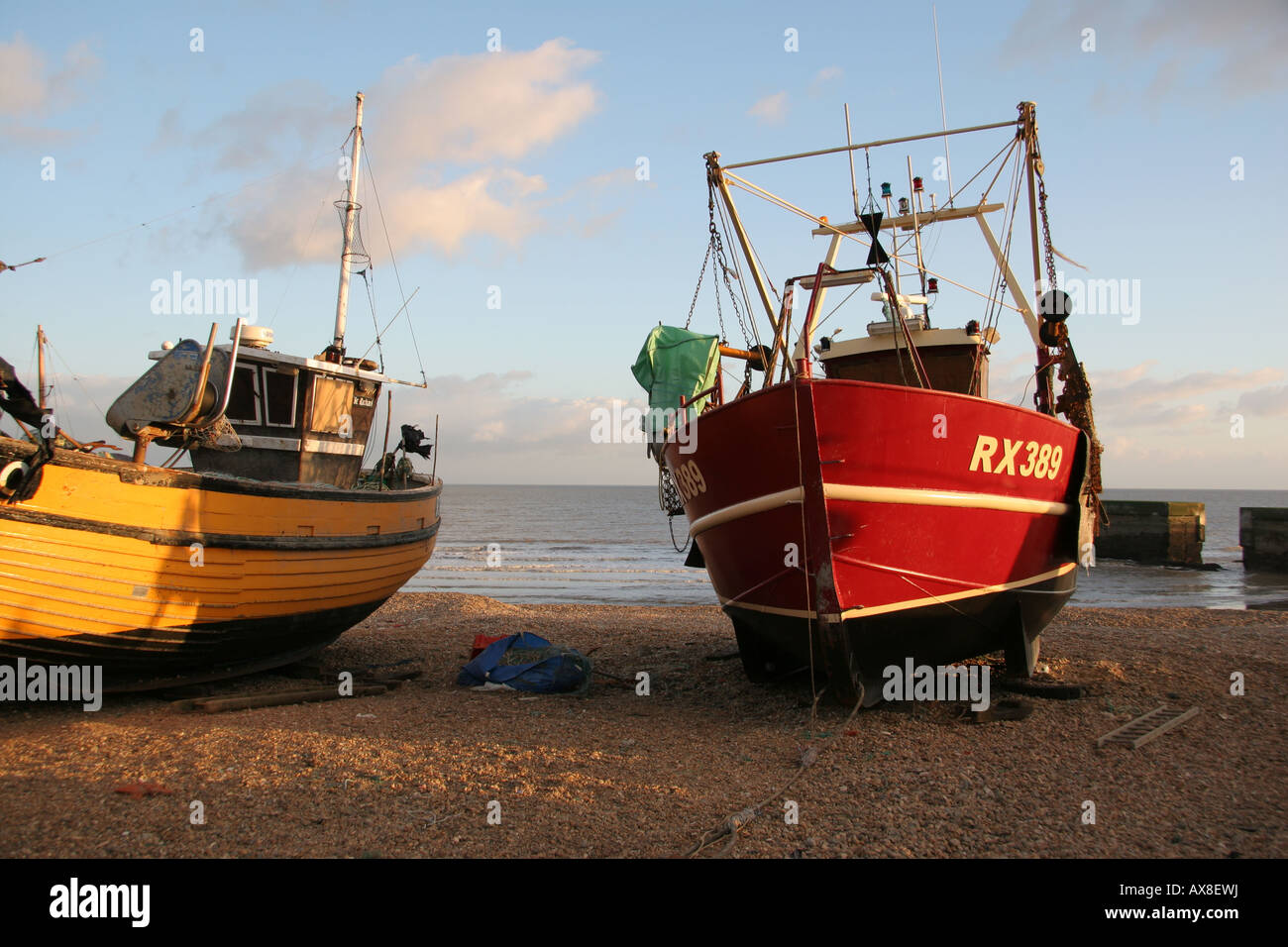Red fishing boat front view alongside yellow fishing boat Stock Photo ...