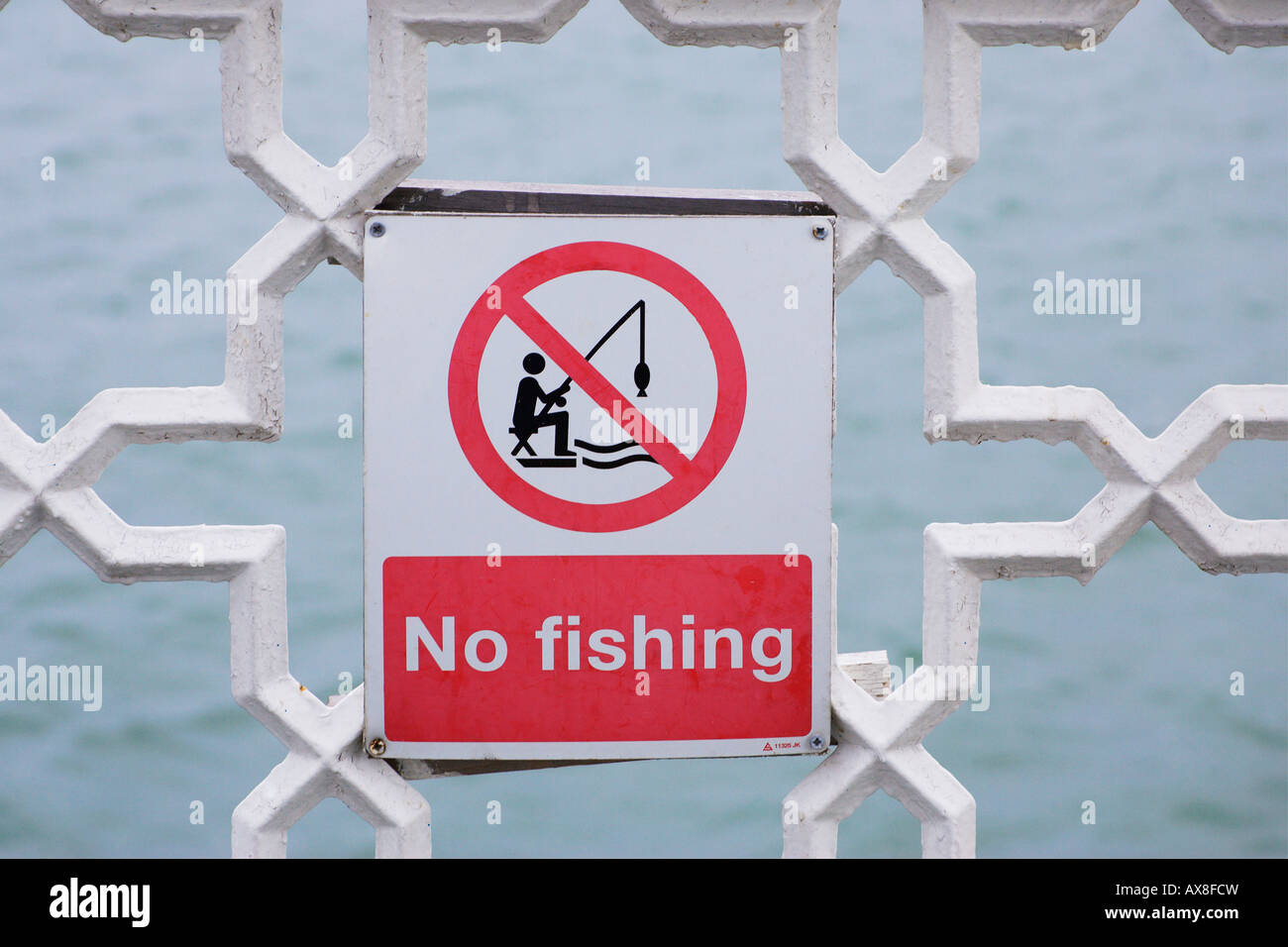 Ornate wrought iron railing with no fishing sign Stock Photo - Alamy
