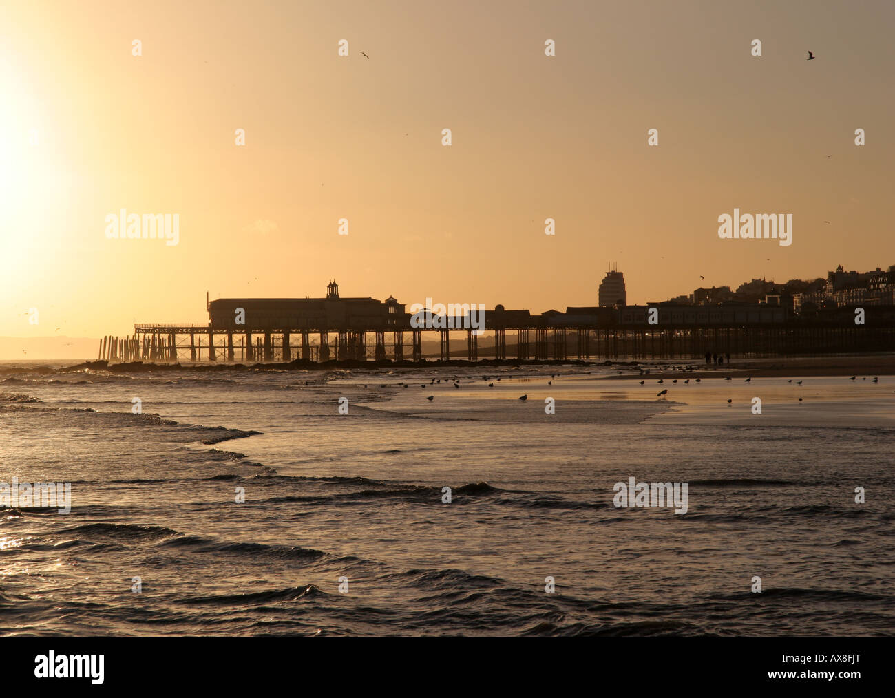 Silhouette hastings pier beach sunset hi-res stock photography and ...