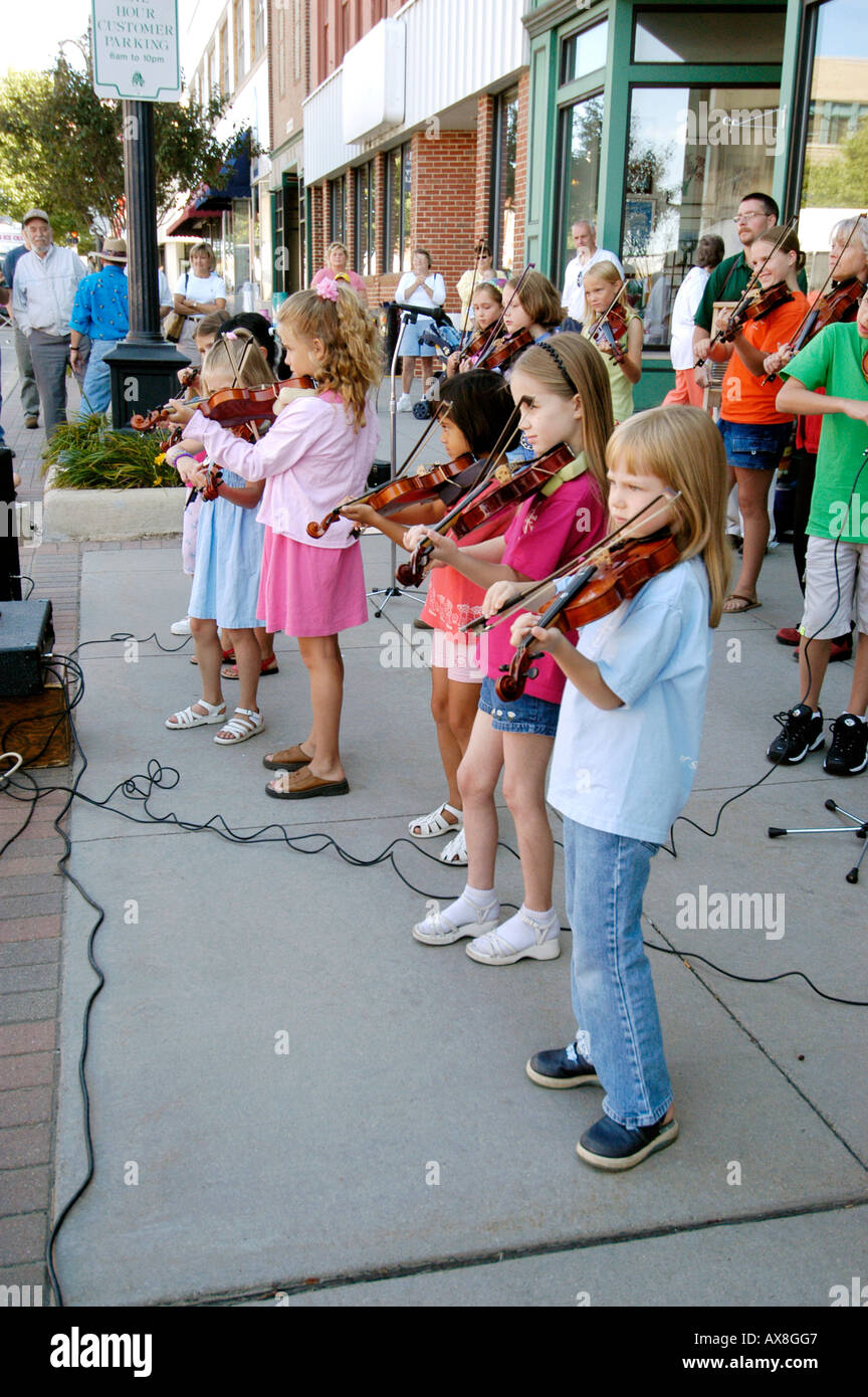 Violin strings group made up of children play a recital outside for the ...