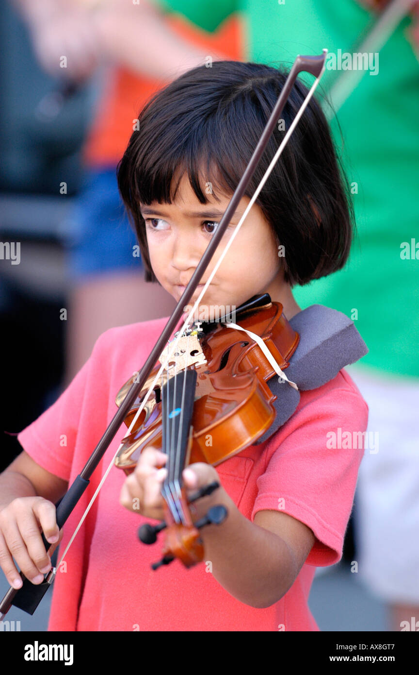 Violin strings group made up of children play a recital outside for the ...