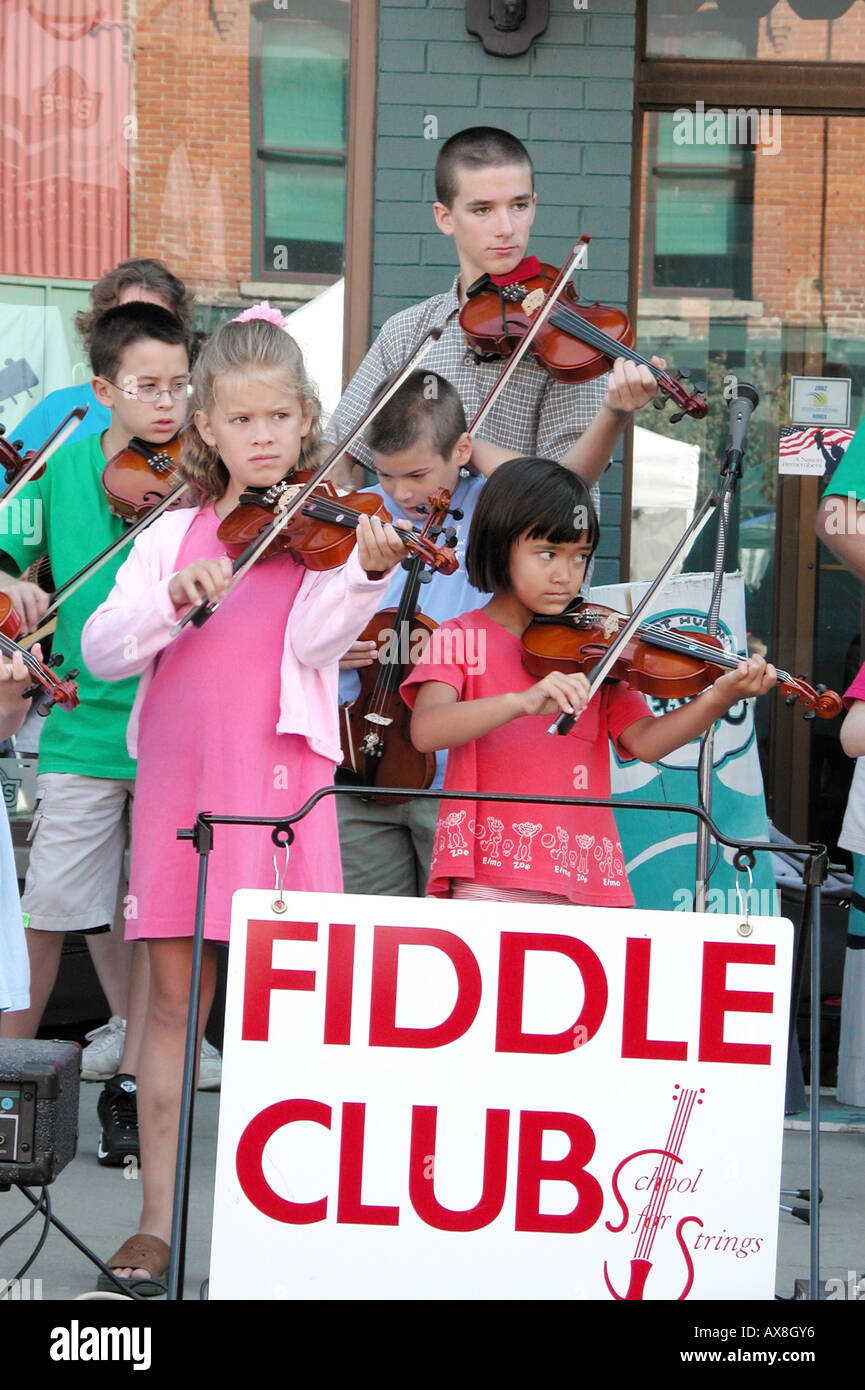 Violin strings group made up of children play a recital outside for the ...