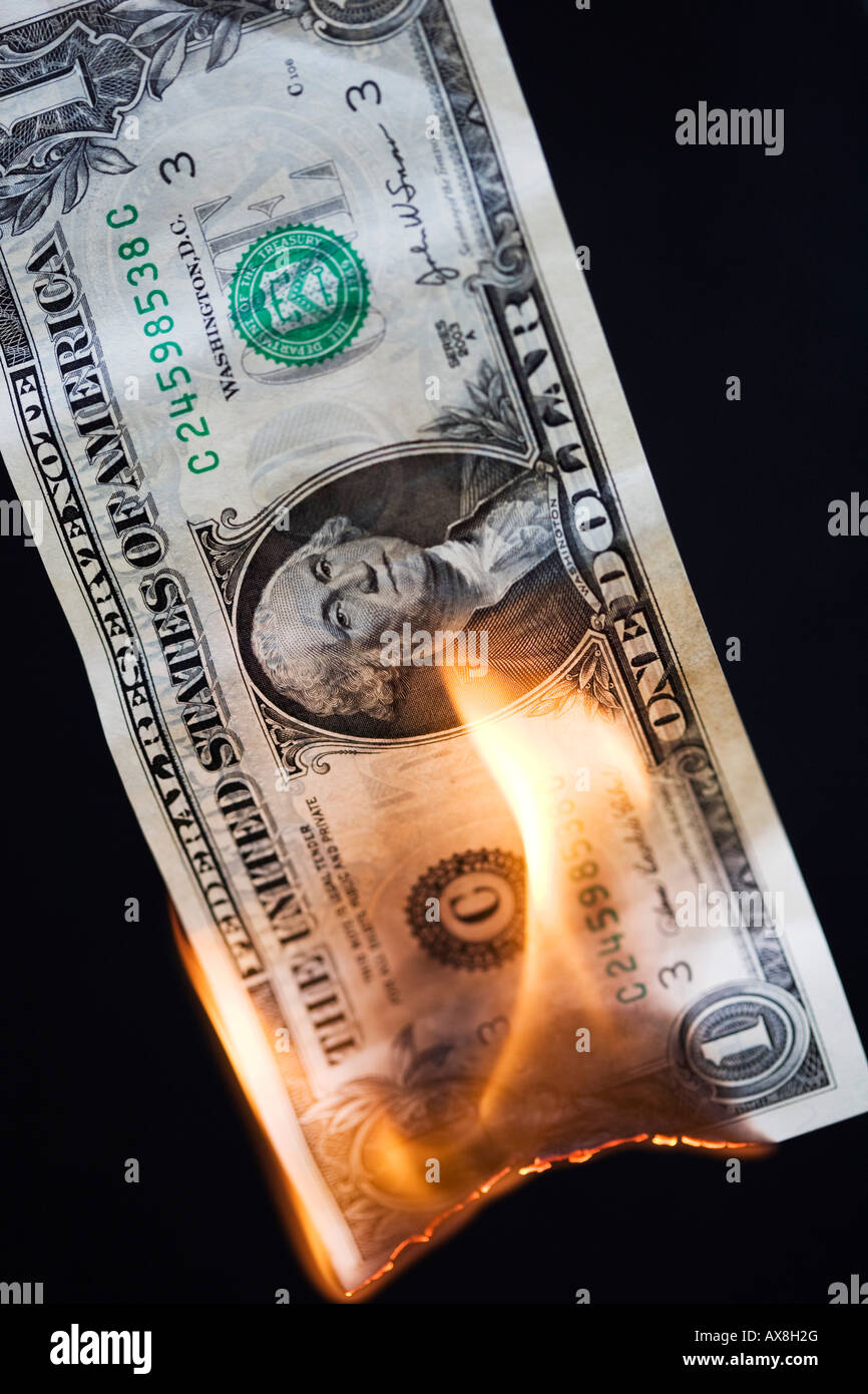 American dollar bill burning concept Stock Photo - Alamy