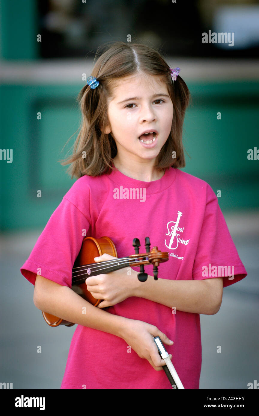 Violin strings group made up of children play a recital outside for the ...