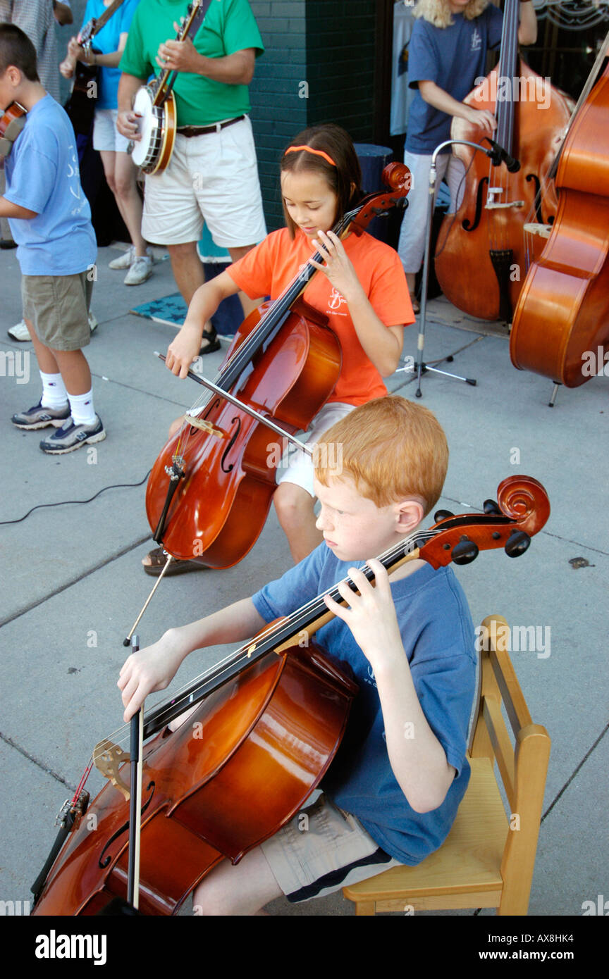 Violin strings group made up of children play a recital outside for the ...