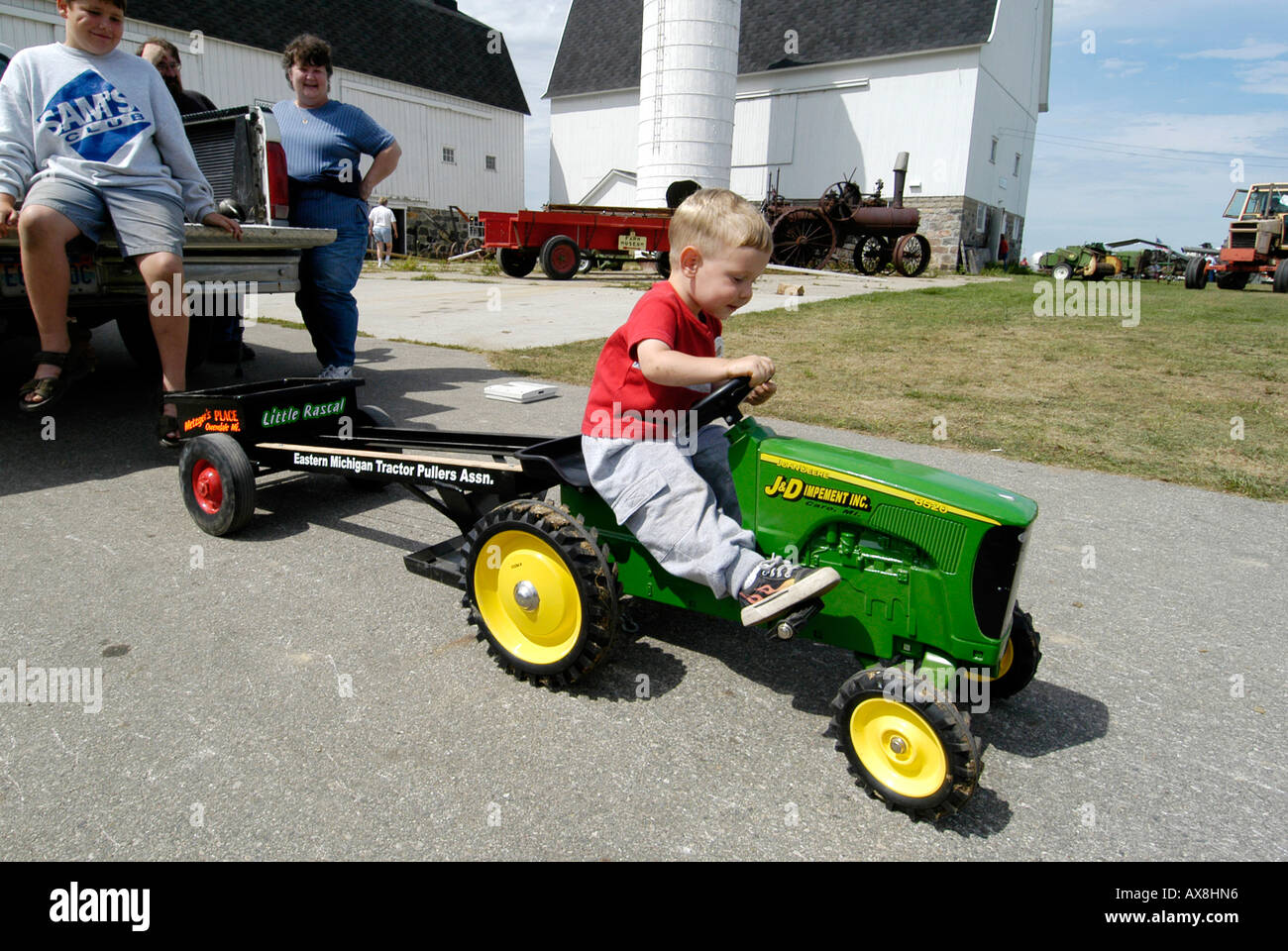 Child plays on tractor in a simulated tractor pull contest Stock Photo ...