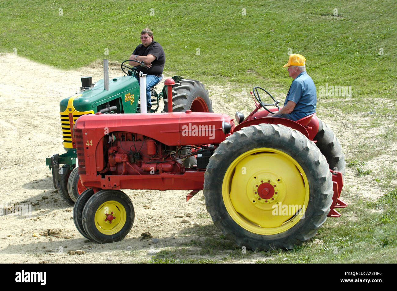 Portrait of a male farmer sitting on a tractor Stock Photo - Alamy
