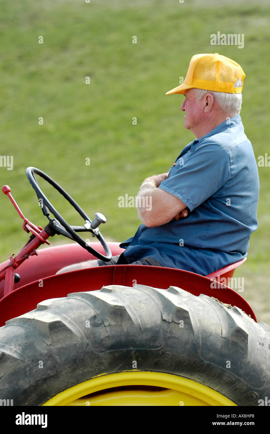 Portrait of a male farmer sitting on a tractor Stock Photo - Alamy