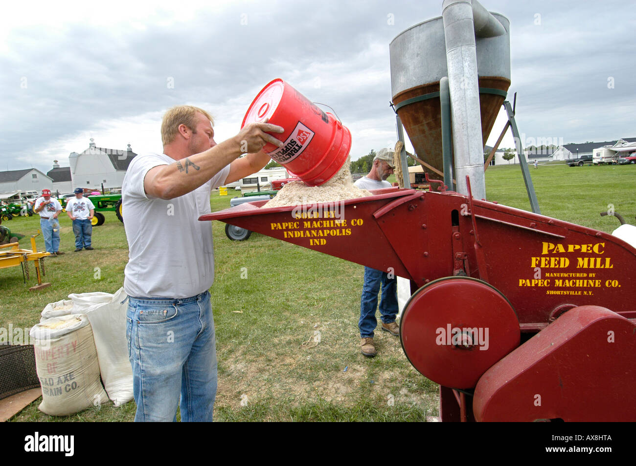 Farmer mixing grains and preparing them for fee to cattle Stock Photo ...