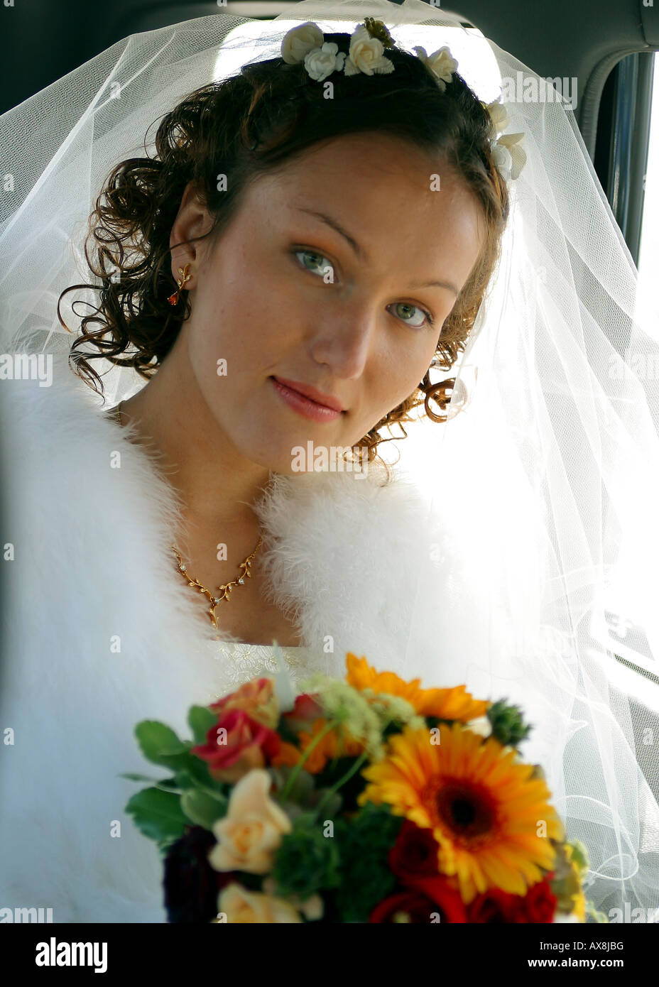 Beautiful bride with bouquet, in wedding car limousine Stock Photo - Alamy