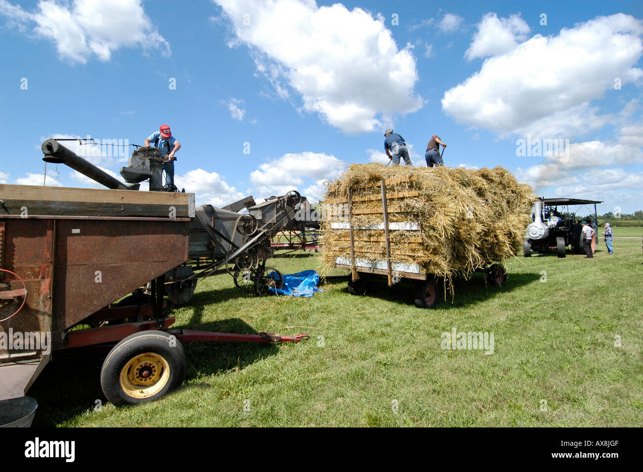Living history demonstration of threshing oats with steam power at an ...