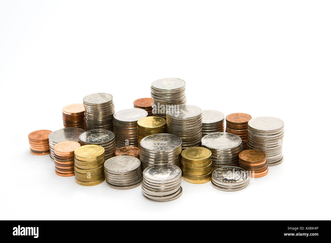 Stack of coin on table with white background Stock Photo - Alamy