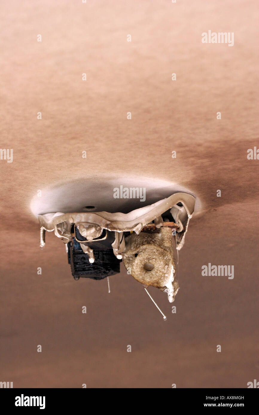 A smoke alarm that has melted and is damaged from a house fire Stock ...