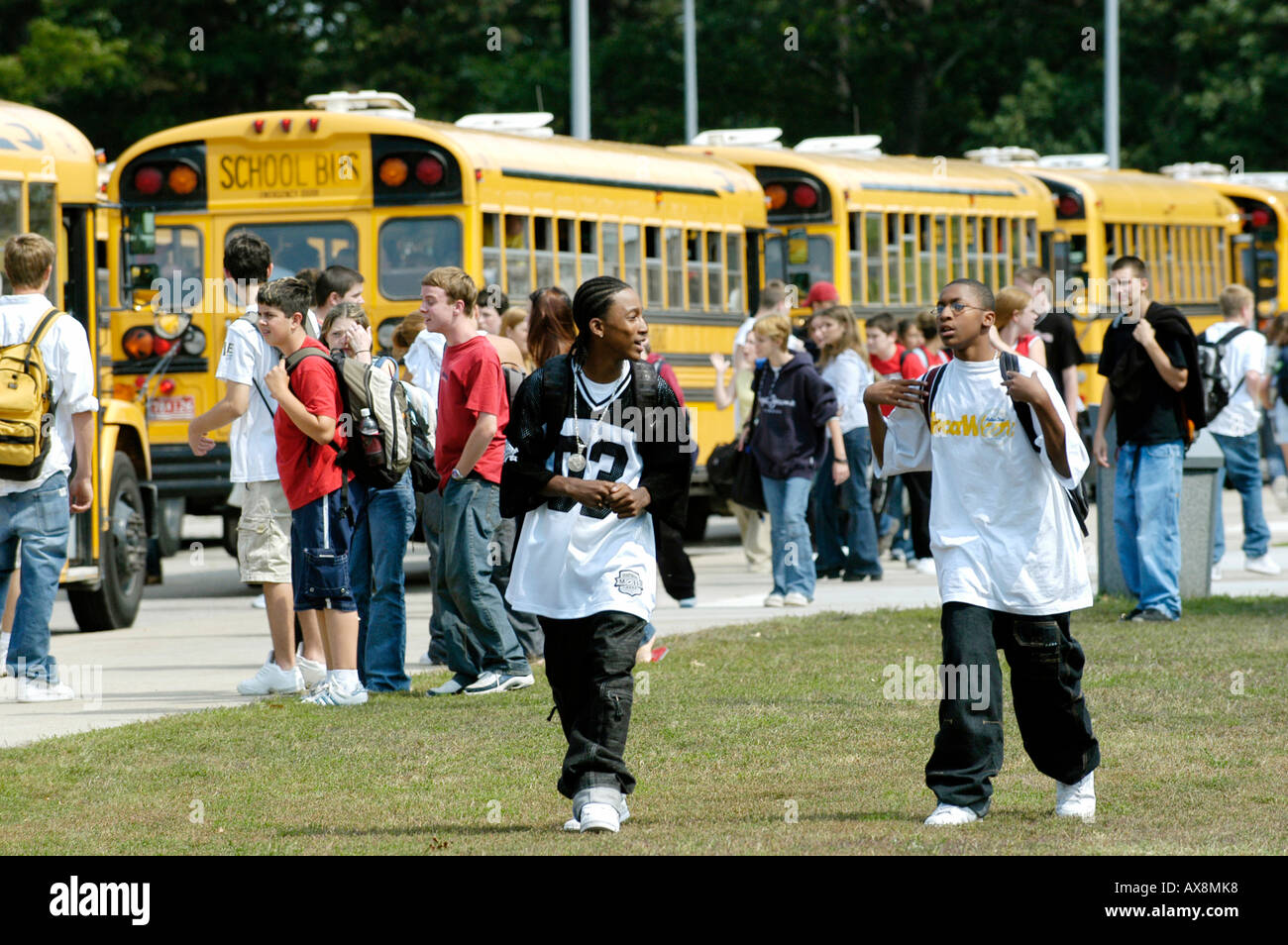 High school students leave at the end of the day to ride school busses ...