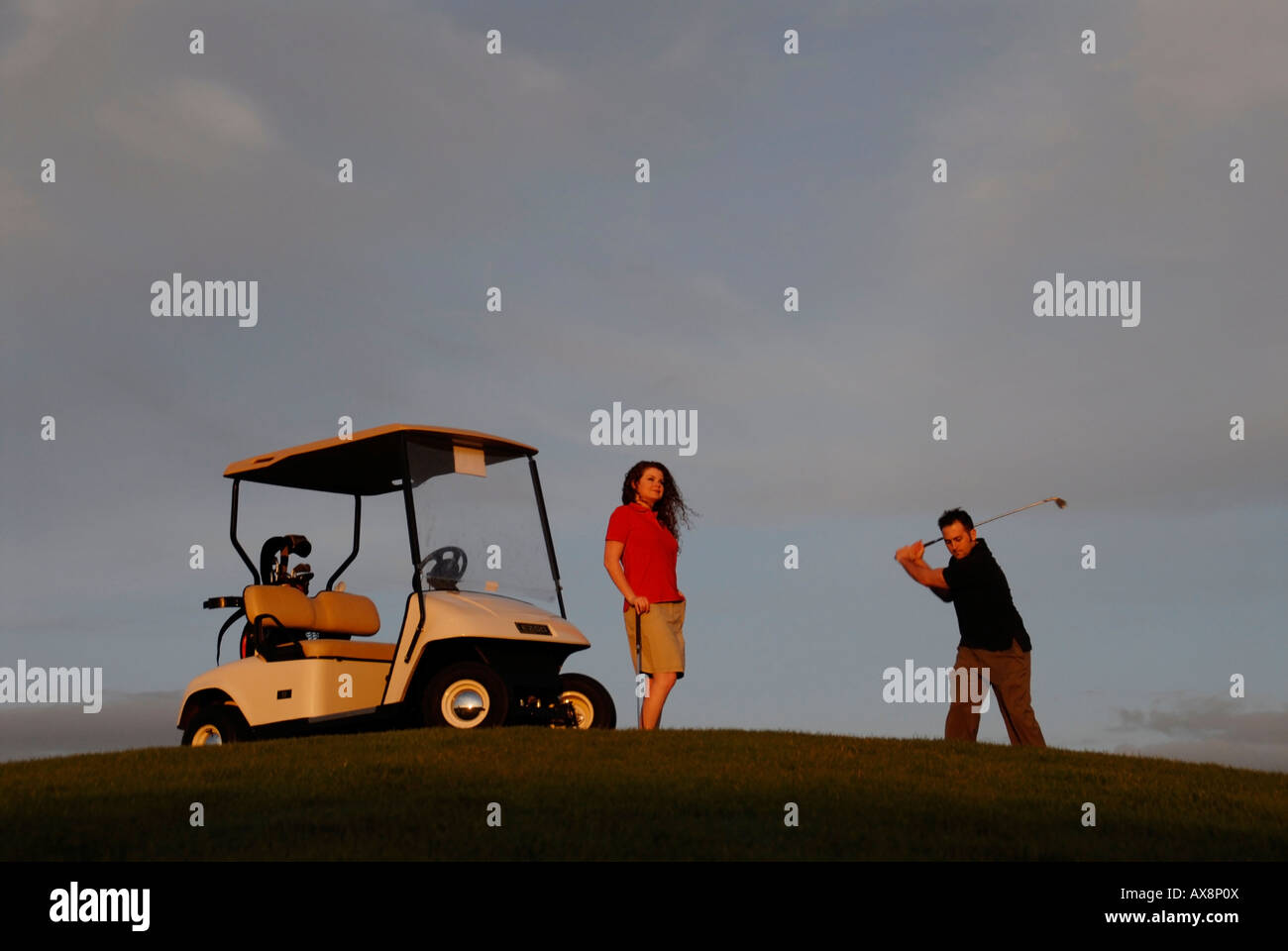 Cassie and Jeff Scherer golfing at sunset Stock Photo - Alamy