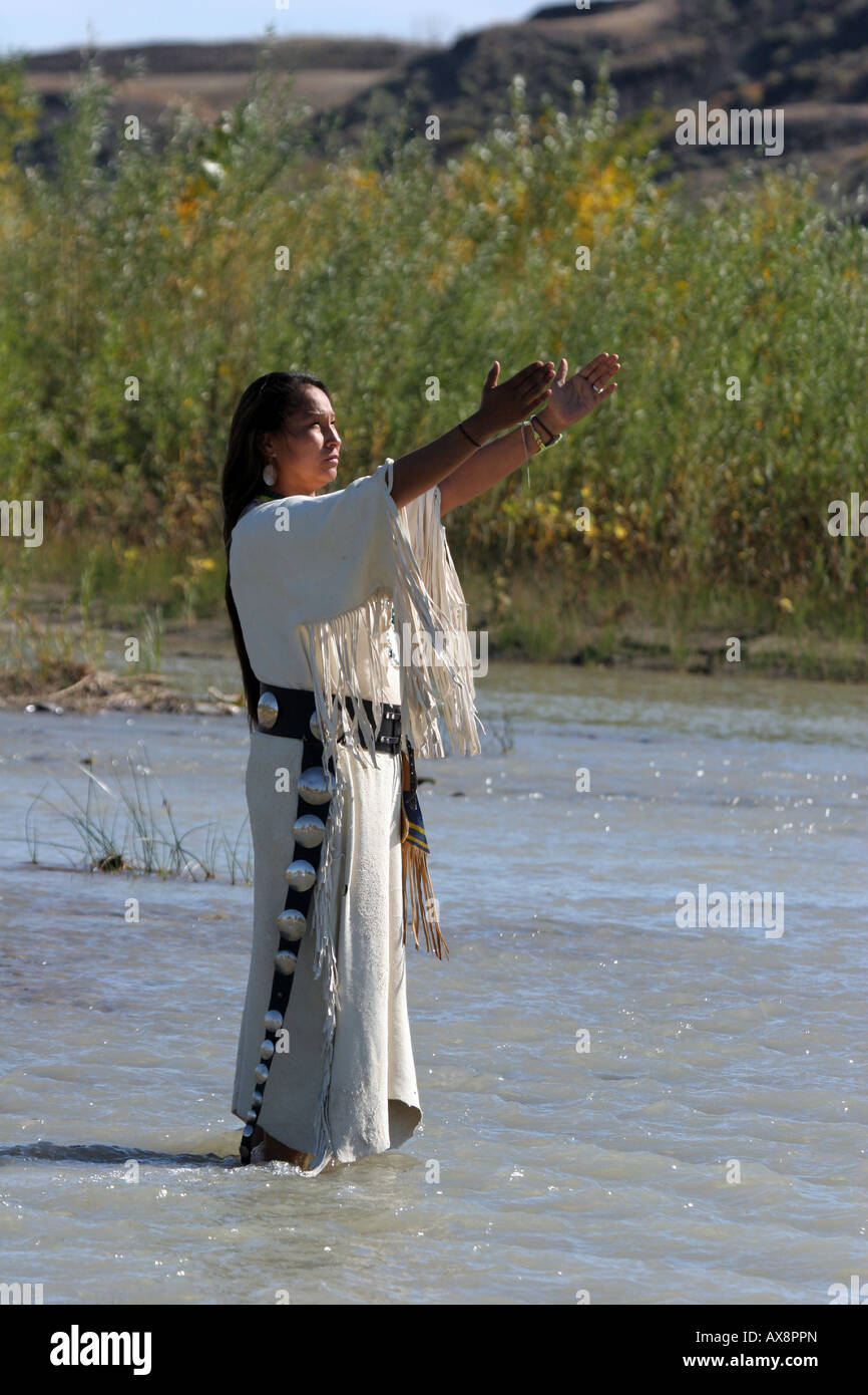 A Native American Indian women holding her hands up to the sun on a ...