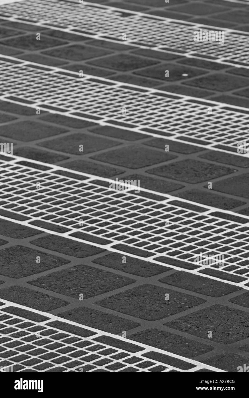 The graphic lines of a pedestrian sidewalk crossing on the surface of a ...