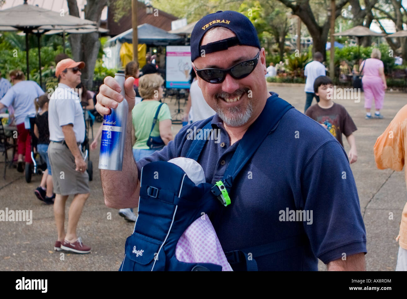 Man with Simulated Real Baby and Real Beer, Carries Fake Child for ...