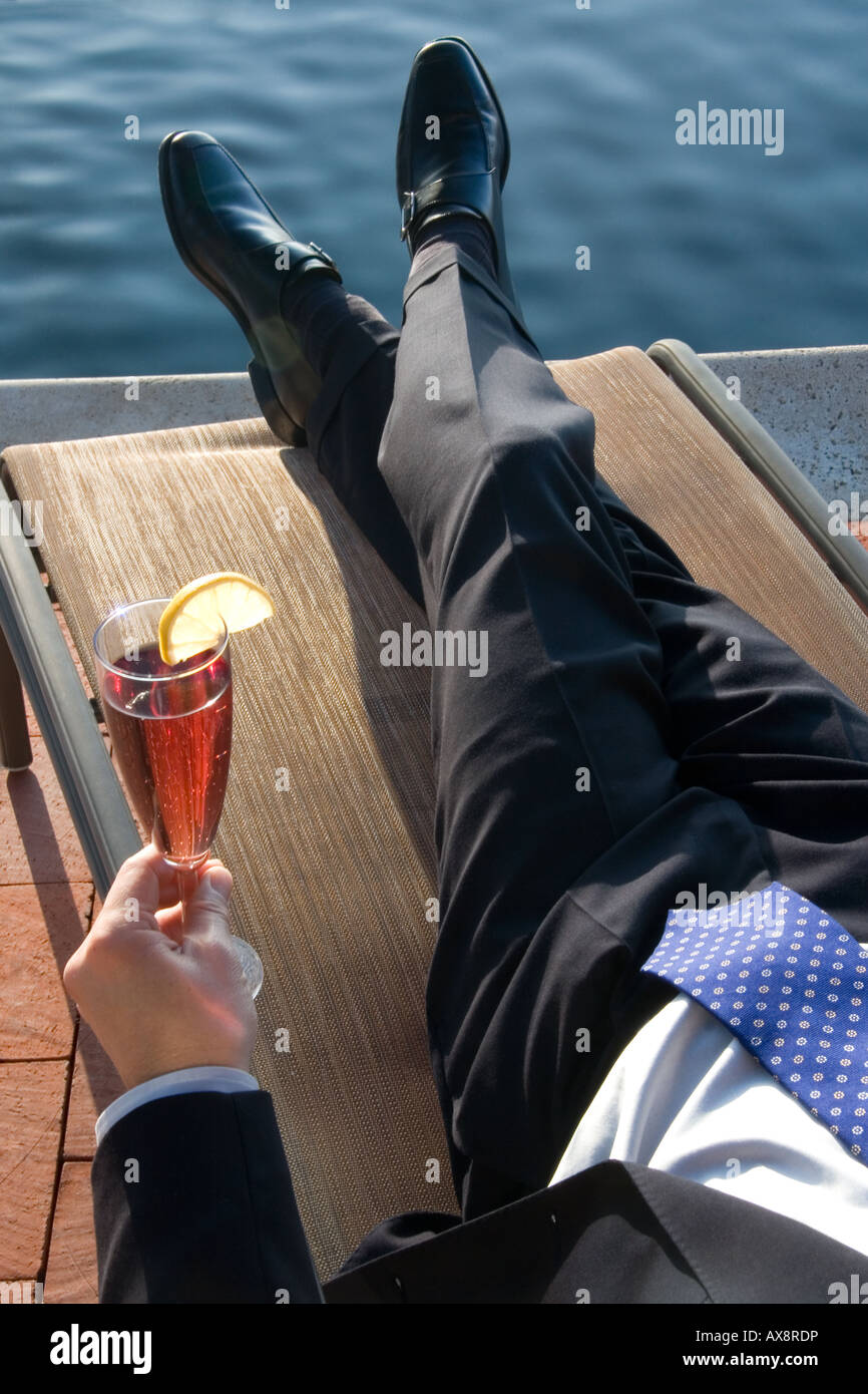 Executive relaxing by the pool Stock Photo - Alamy
