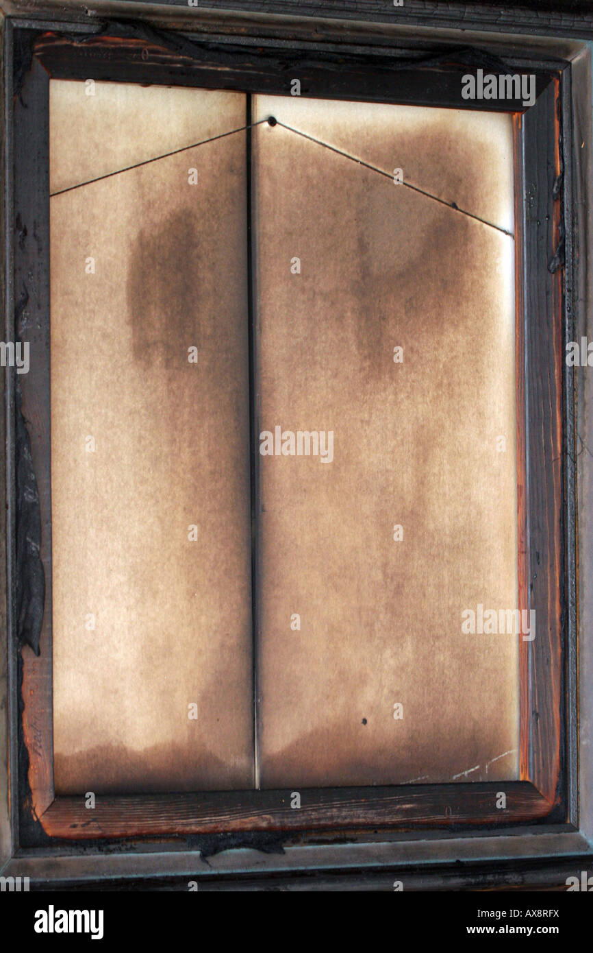A burnt picture frame hanging on the wall Stock Photo - Alamy