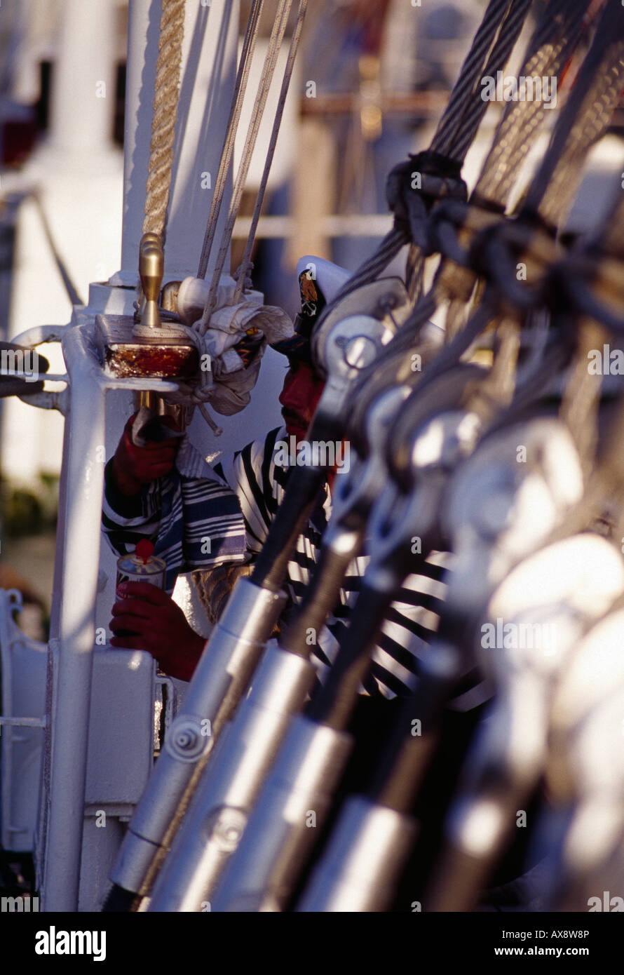 Crew member cleaning part of Mexican tall ship Cuauhtemoc Tournement of ...