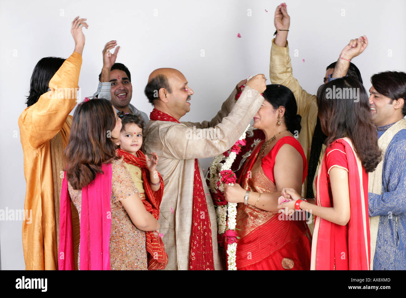 Senior couple getting married with their relatives standing aroung them ...