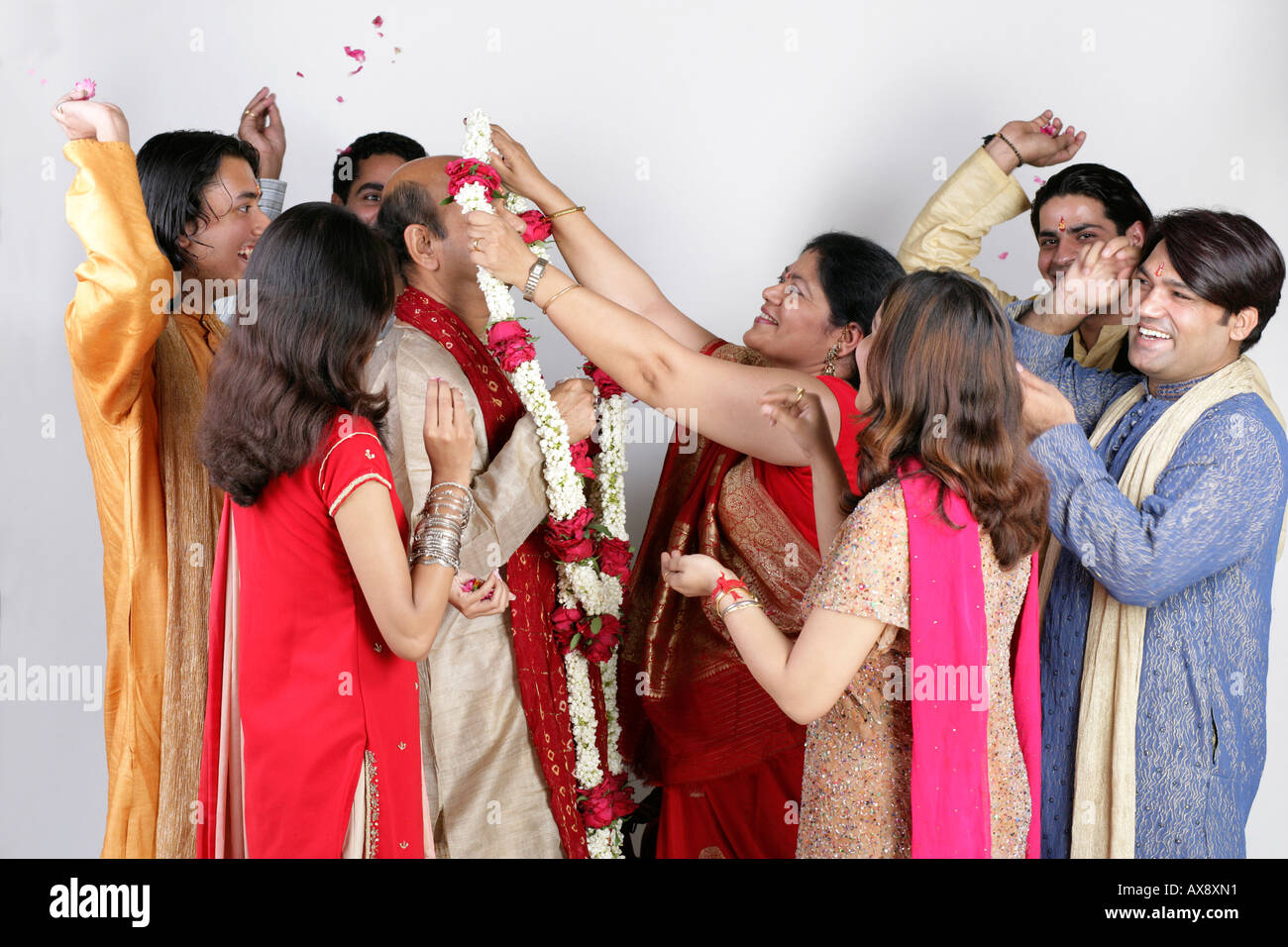 Senior couple getting married with their relatives standing aroung them ...