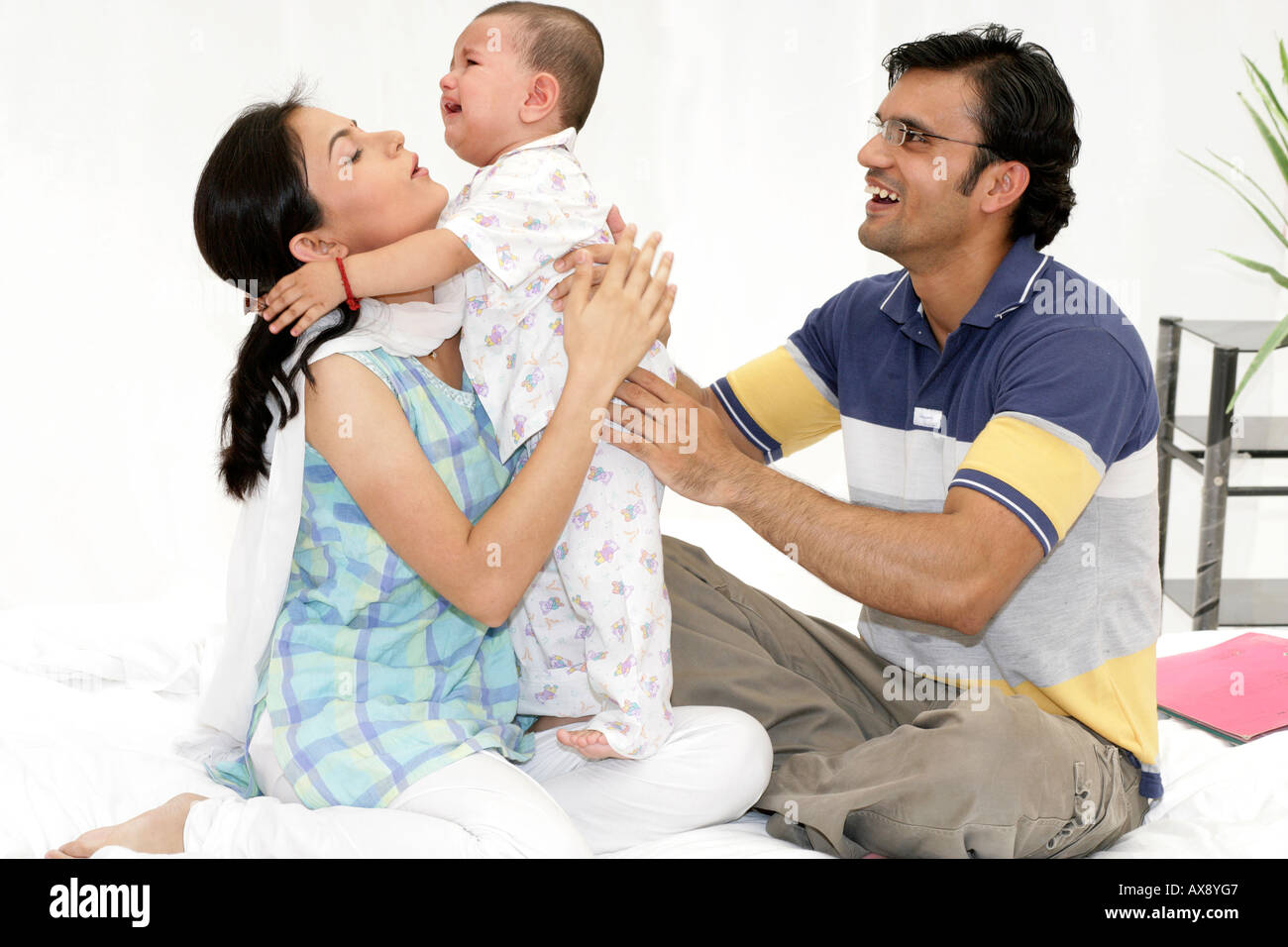 Parent pacifying a crying baby son Stock Photo - Alamy