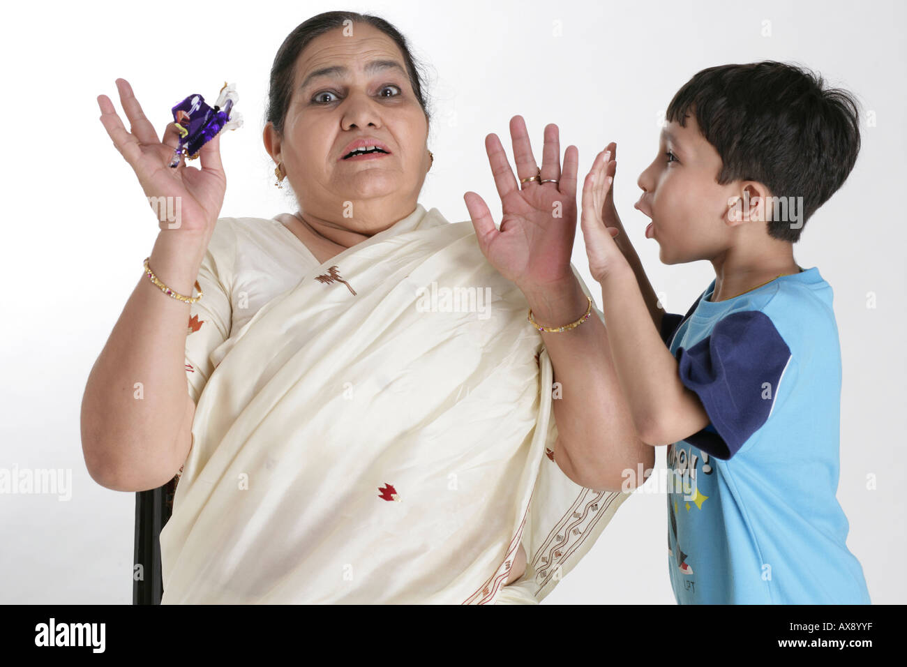 Boy scaring his grandmother Stock Photo - Alamy