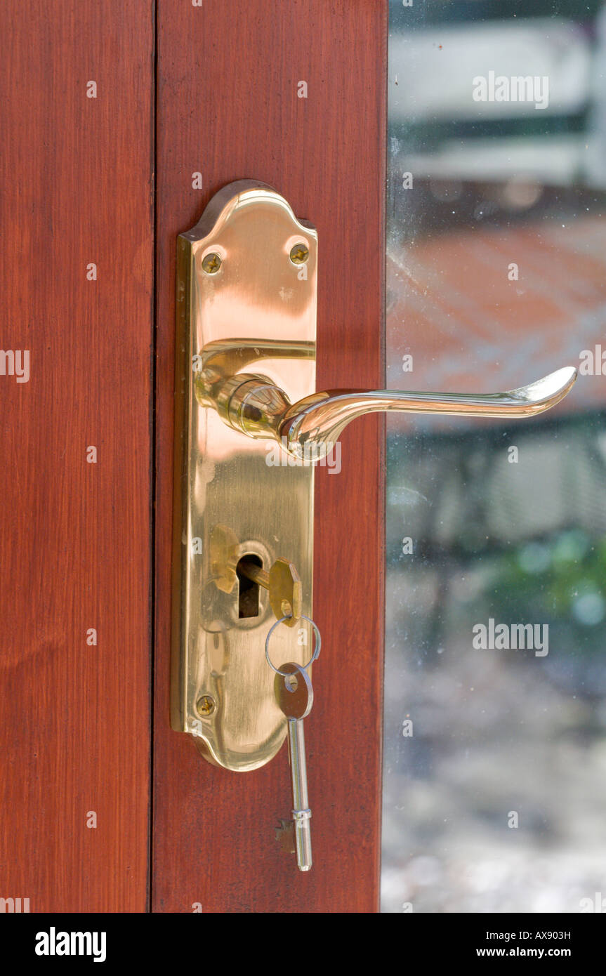 A key in door illustrating security Stock Photo - Alamy