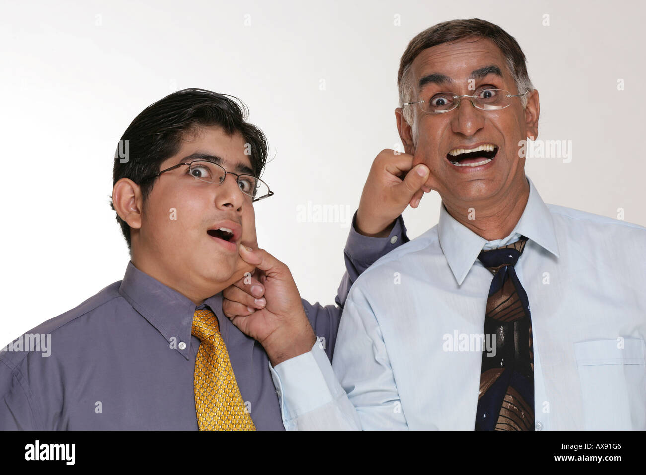 Portrait of a Businessman and his son pinching each other's cheek Stock ...