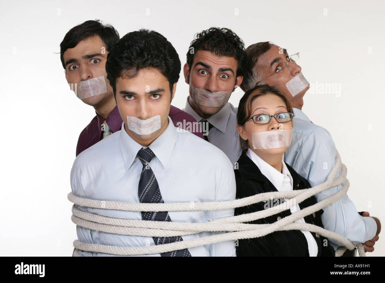 Portrait of five business people tied up with ropes Stock Photo - Alamy