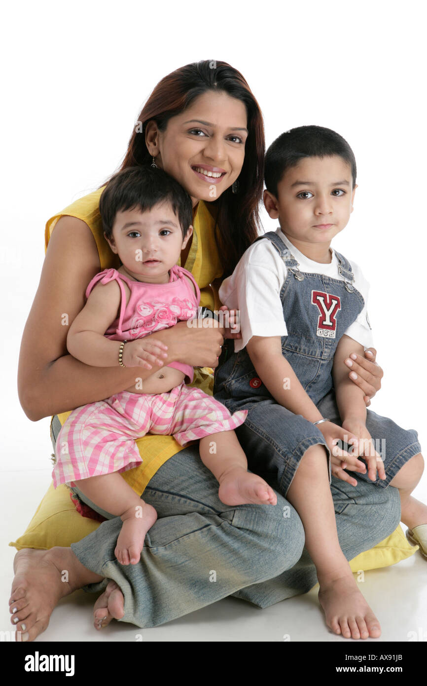 Portrait of an adult woman sitting with her children Stock Photo - Alamy
