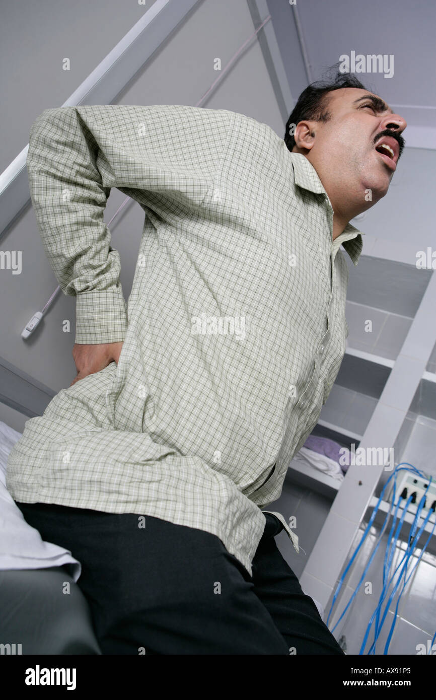 Low angle view of a man suffering from backache in a hospital Stock ...