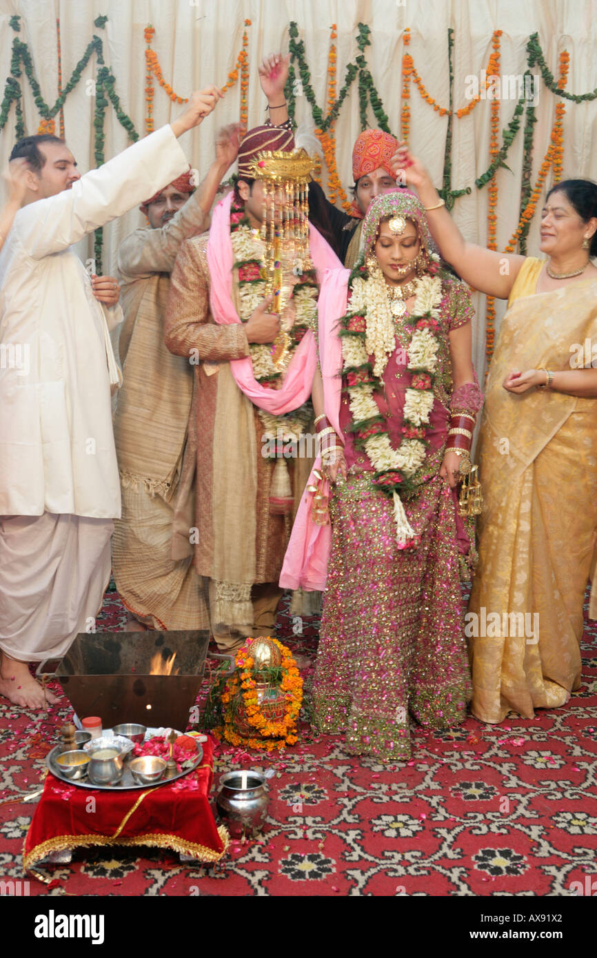 Bride groom getting married with their relative standing around them ...