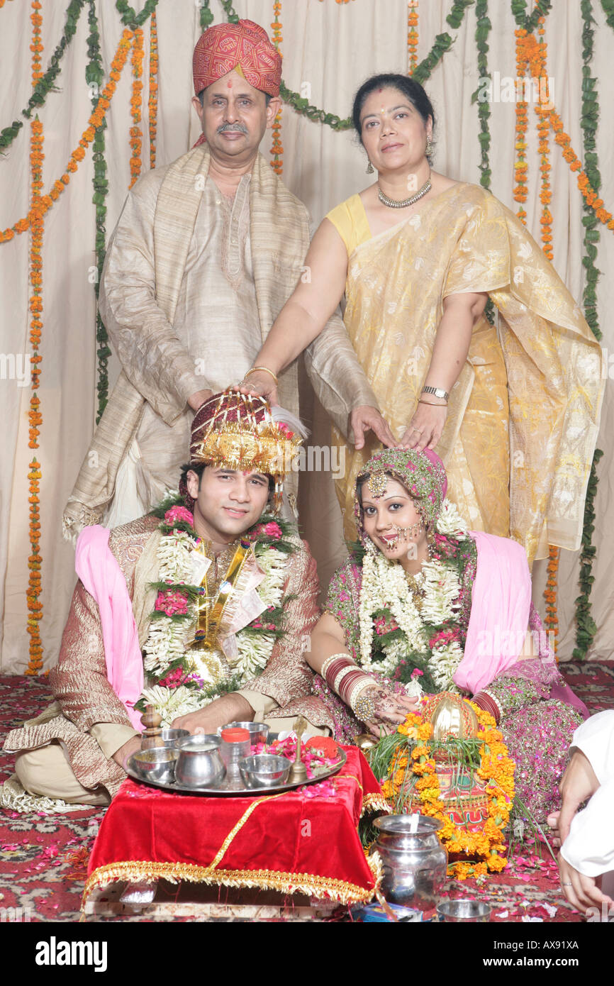 Portrait of a bride and groom getting married and their parents ...