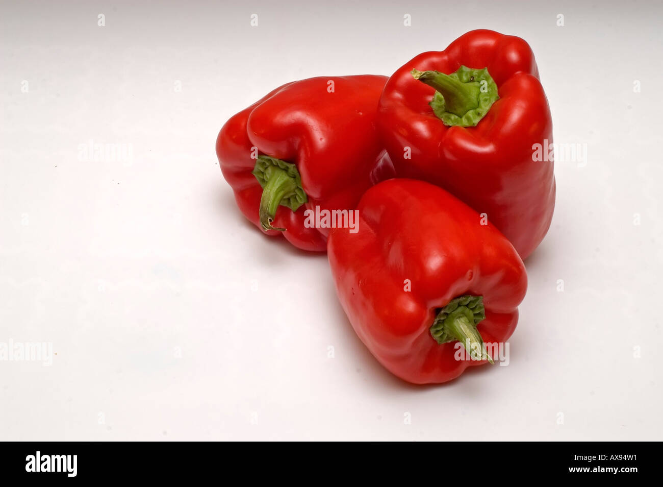 Three Red pepper still life on a white background Stock Photo - Alamy