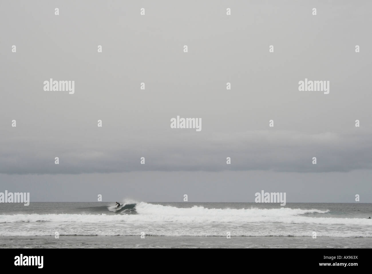 Surfer riding the waves in poor conditions at Majanicho north beach on ...