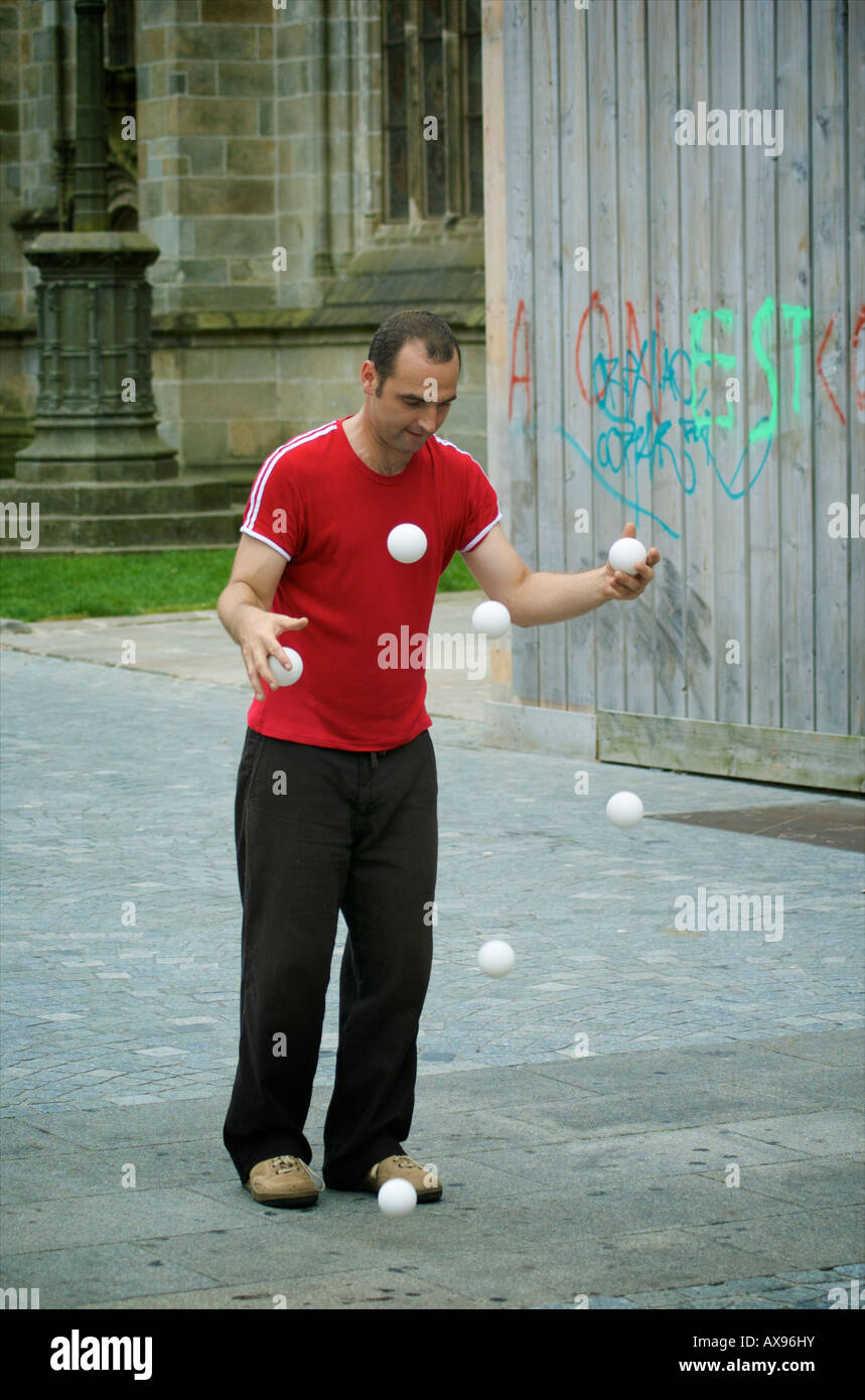 A juggler entertaining tourists in the city of Quimper in Brittany ...