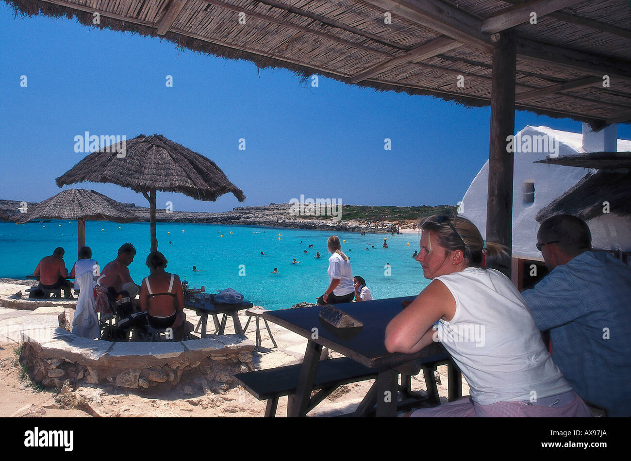 People sitting in a beach bar, Cala Binibeca, Minorca, Spain Stock ...