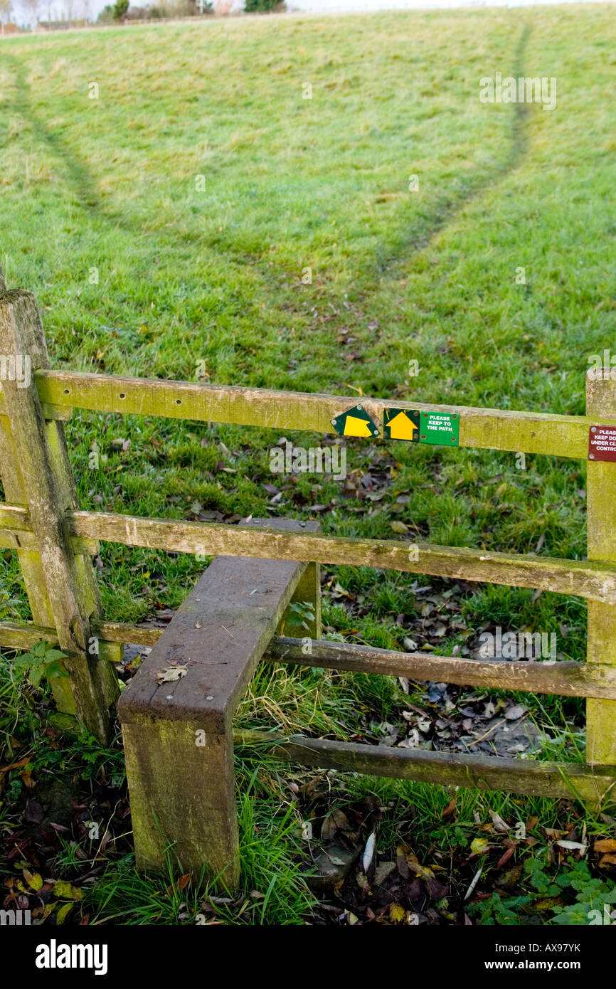 A public footpath stile with a path crossing a field Stock Photo - Alamy
