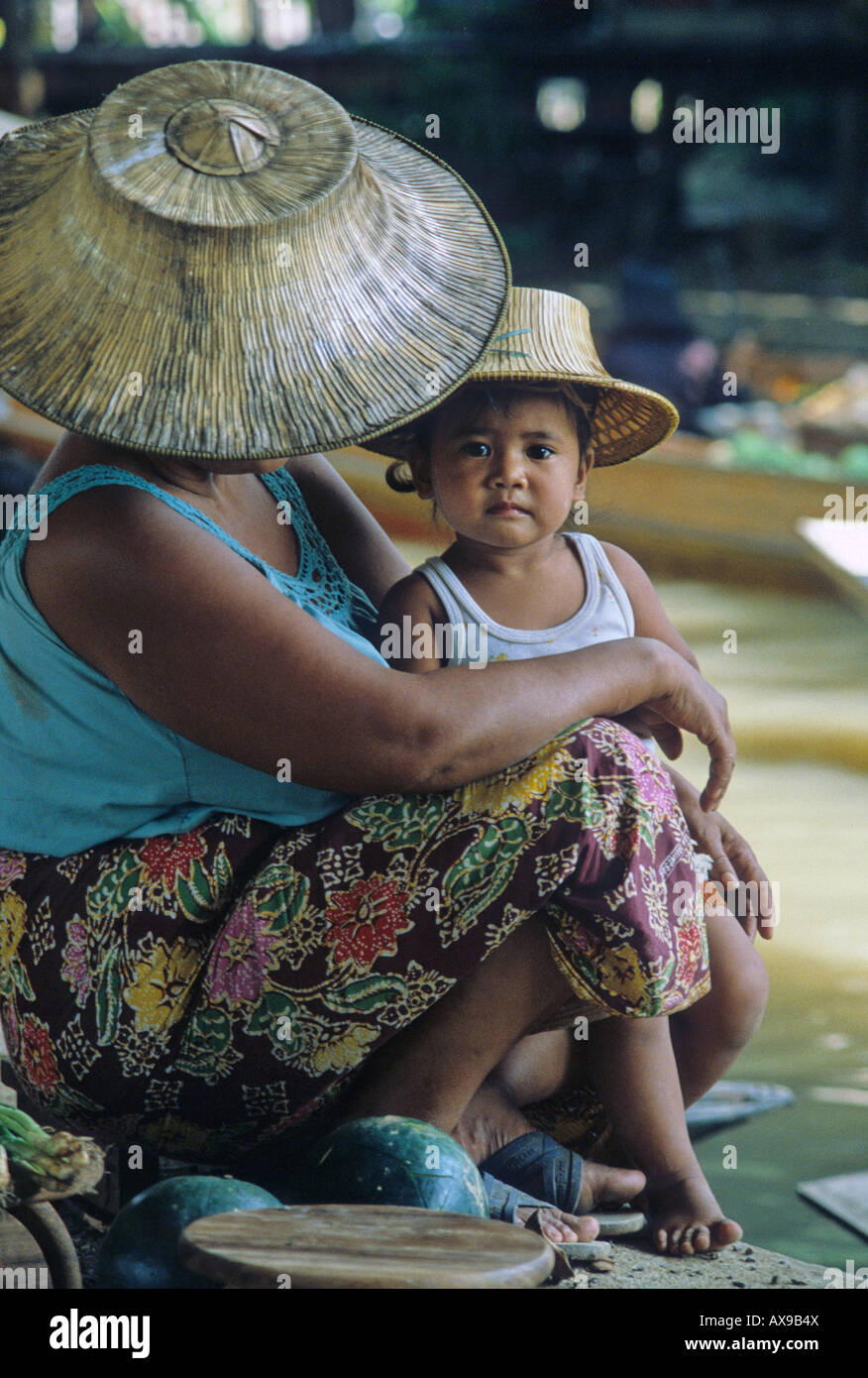 Mother and child both wearing traditional Thai hats, or ngobs, Bangkok ...