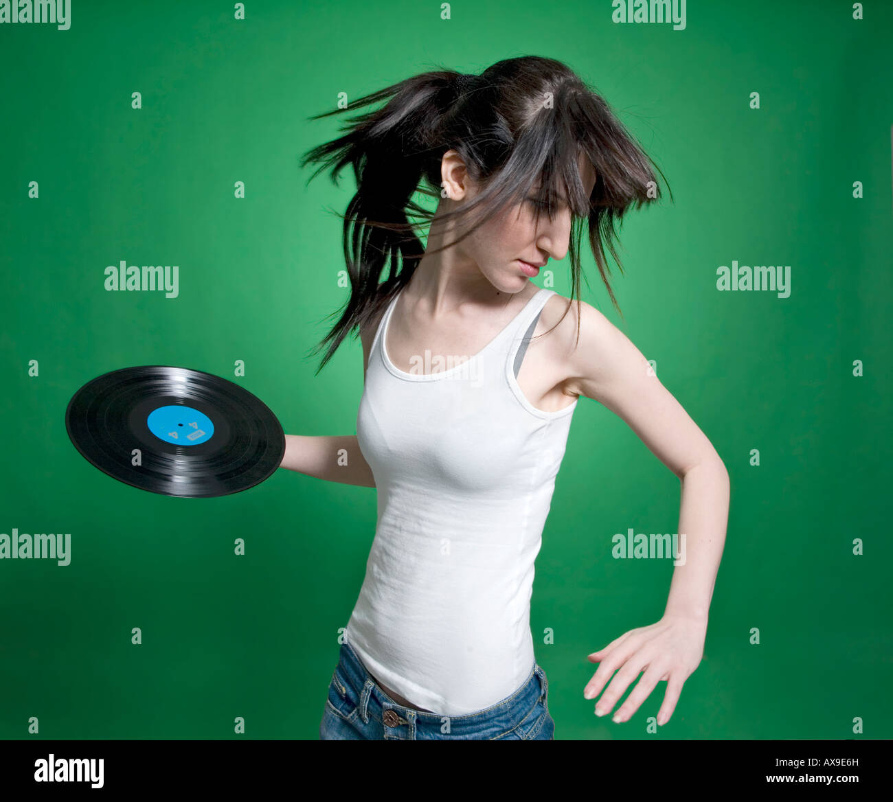 a girl dancing whilst holding a record Stock Photo - Alamy
