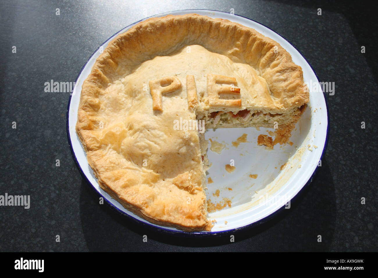 "A cooked chicken pie with the word 'pie' in pastry letters on top and ...